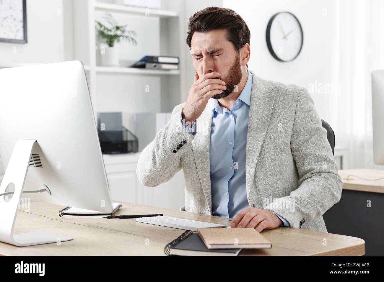 Sick man coughing at workplace in office. Cold symptoms Stock Photo - Alamy