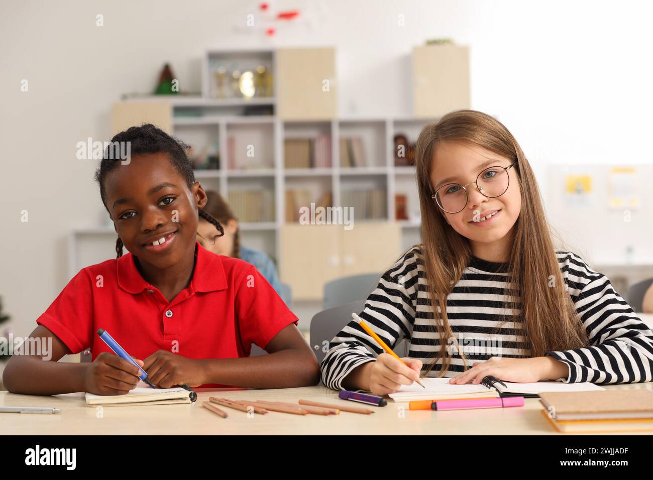 Cute children studying in classroom at school Stock Photo - Alamy