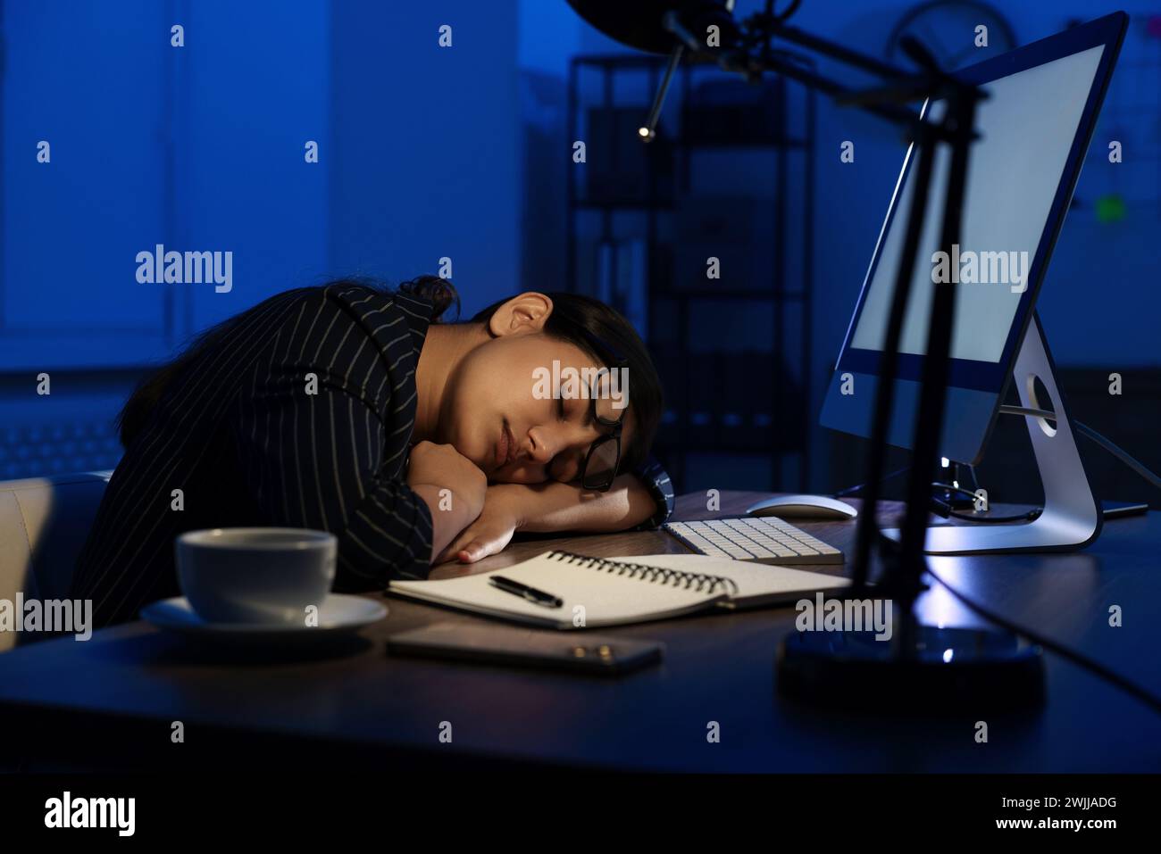 Tired overworked businesswoman napping at night in office Stock Photo ...