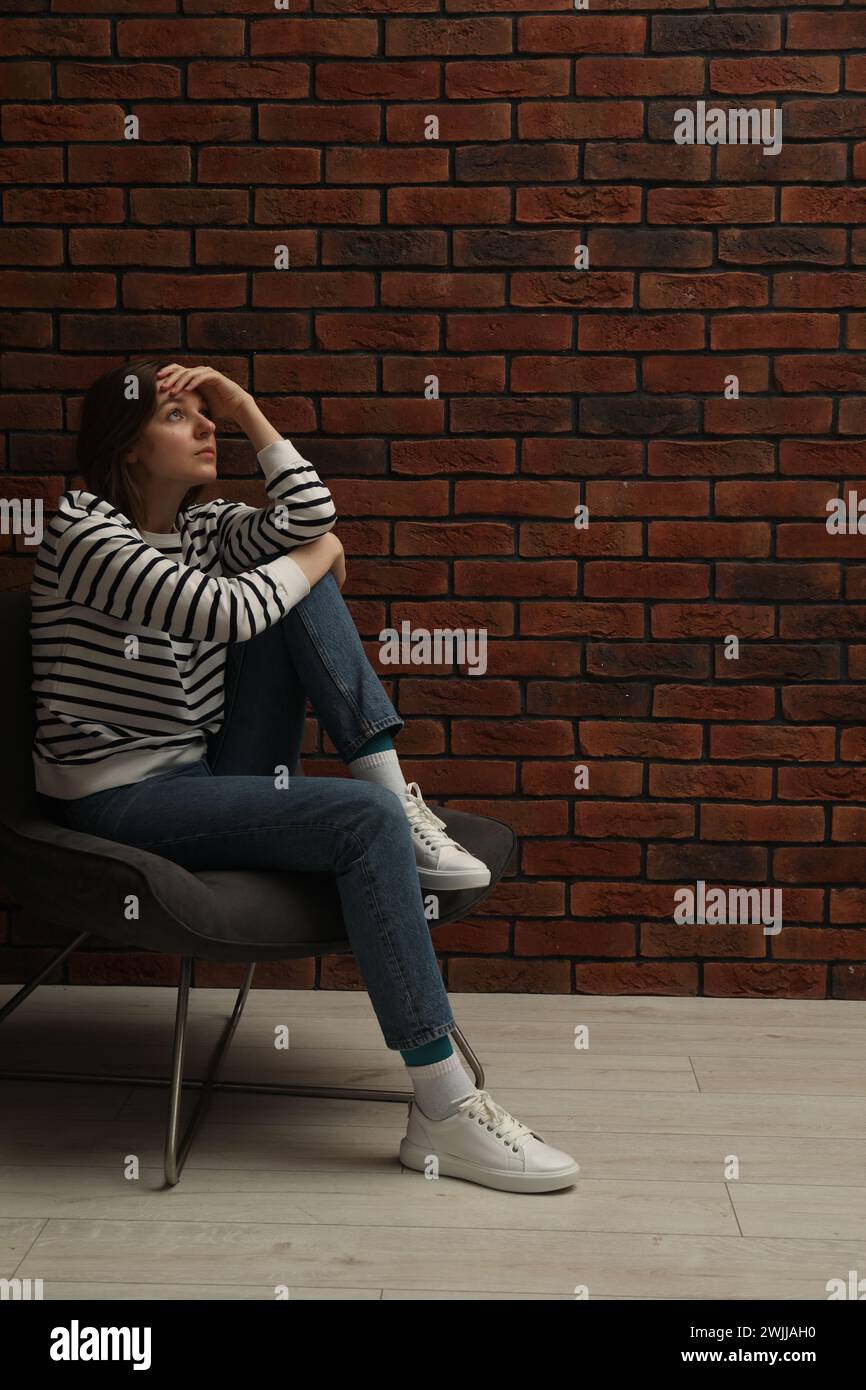 Woman suffering sitting on chair hi-res stock photography and images ...