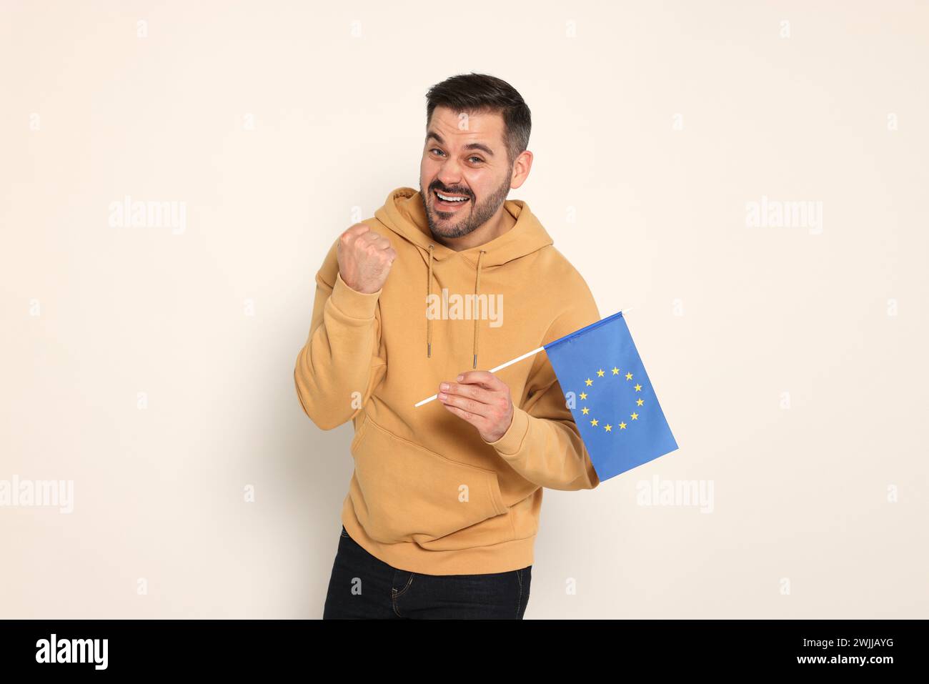 Emotional man with flag of European Union on white background Stock ...