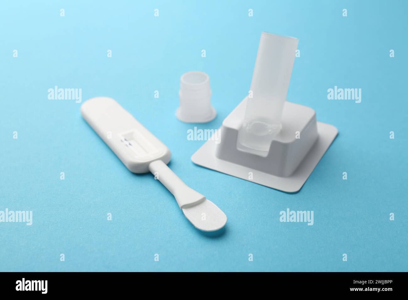 Disposable express test kit on light blue background Stock Photo - Alamy