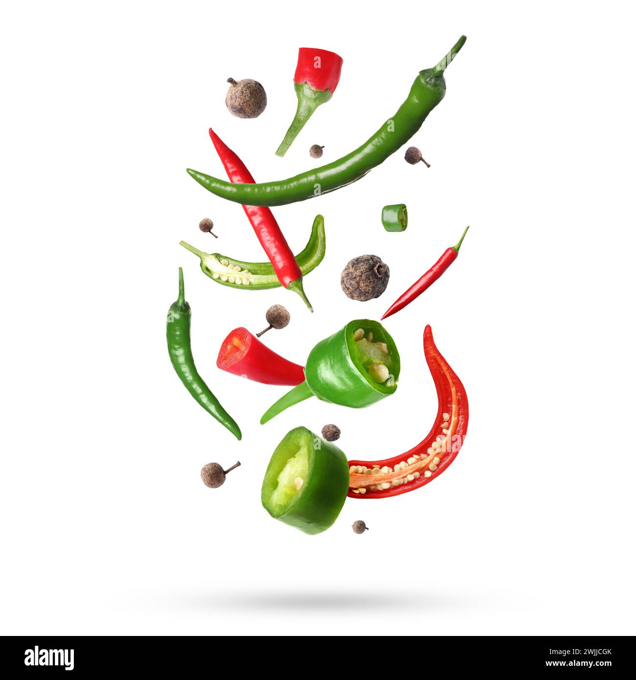 Different aromatic spices falling on white background Stock Photo - Alamy