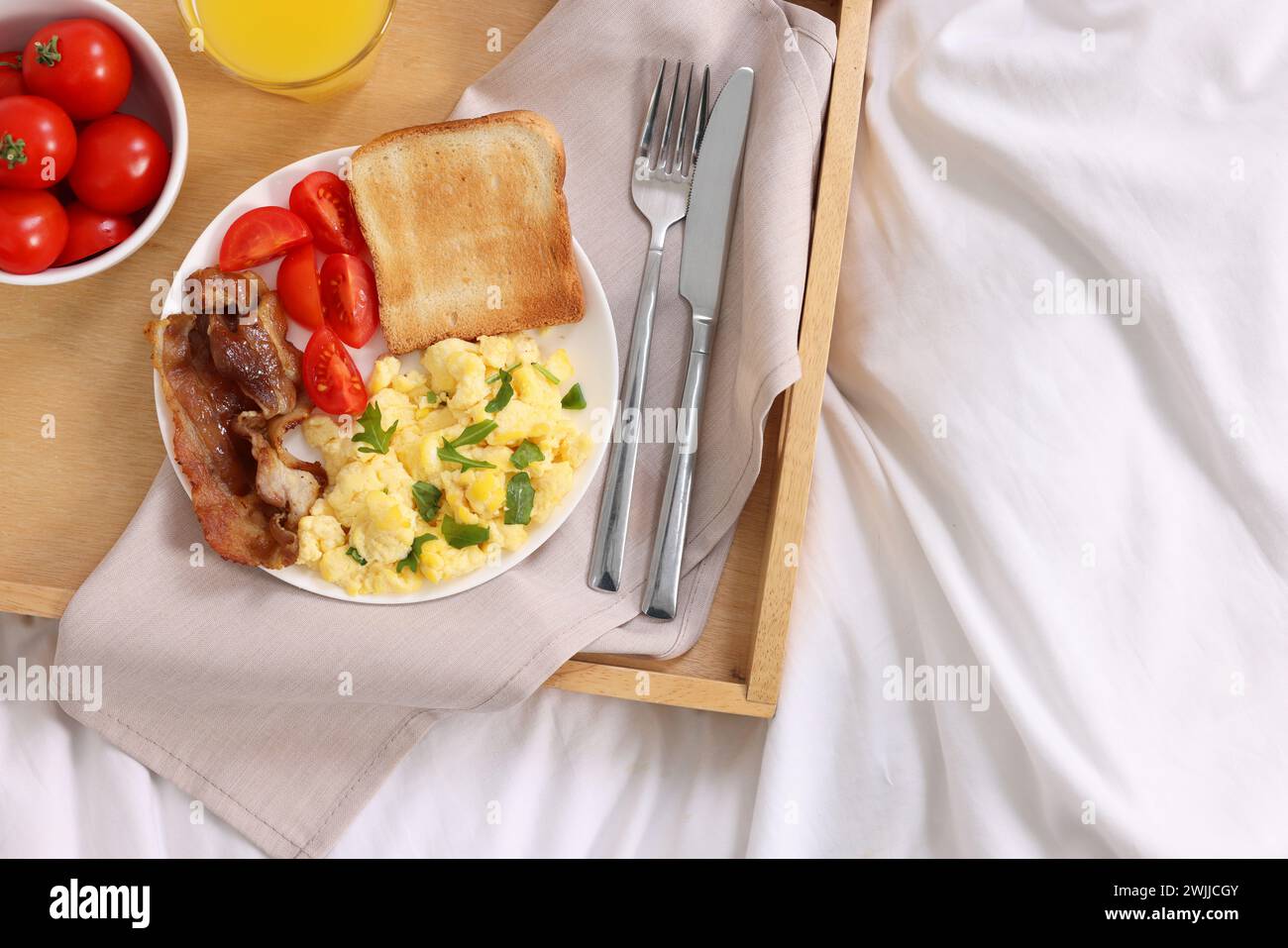 Good morning. Tray with tasty breakfast on bed, top view Stock Photo ...