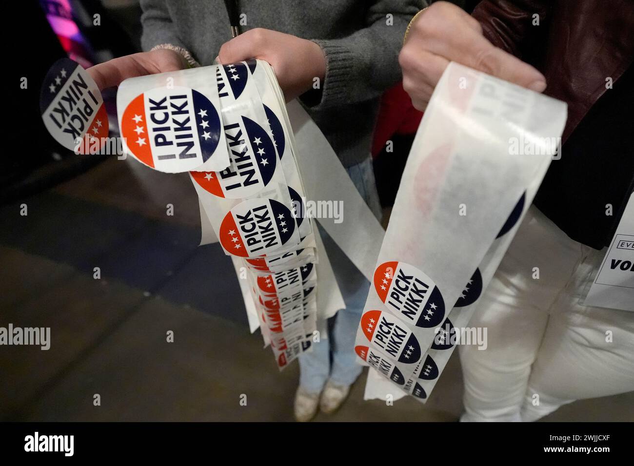 Alex Precourt, holding stickers left, and her mother Agatha, holding ...