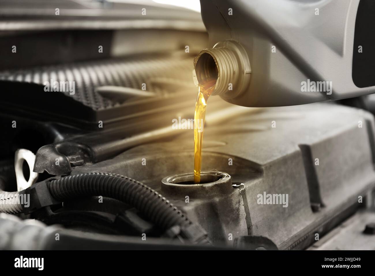 Pouring motor oil into car engine, closeup. Color accent effect Stock ...