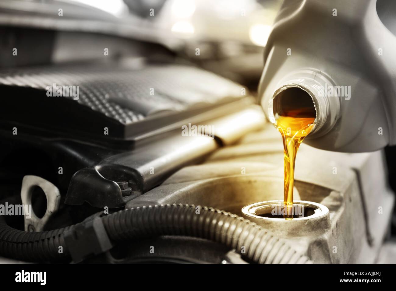 Pouring motor oil into car engine, closeup. Color accent effect Stock ...