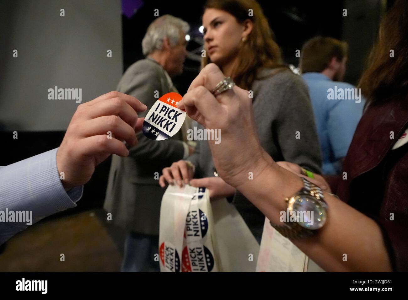 Alex Precourt, center, and her mother Agatha right, handing stickers to ...