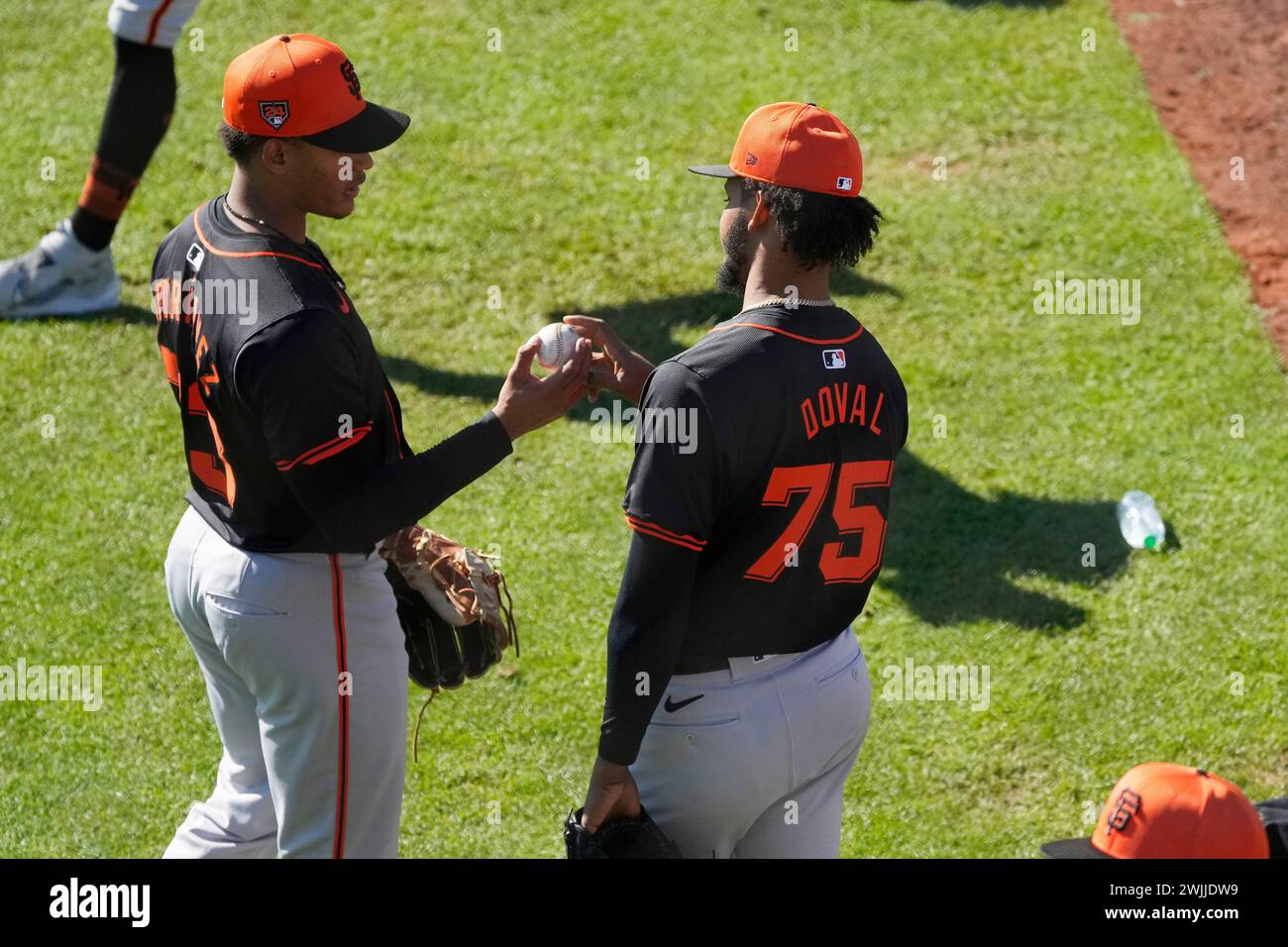 San Francisco Giants pitchers Camilo Doval (75) and Randy Rodriguez work on a pitch grip during ...