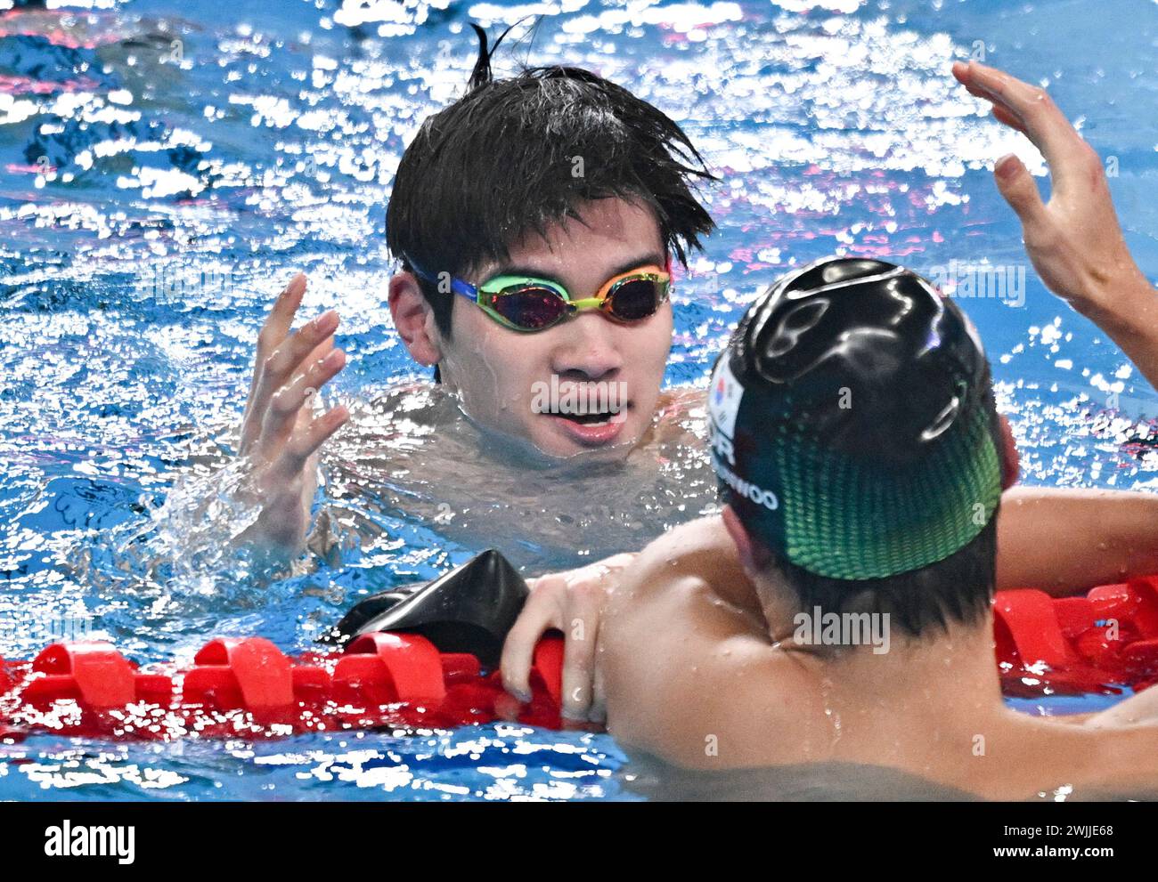 Doha, Qatar. 15th Feb, 2024. Pan Zhanle (L) of China interacts with ...