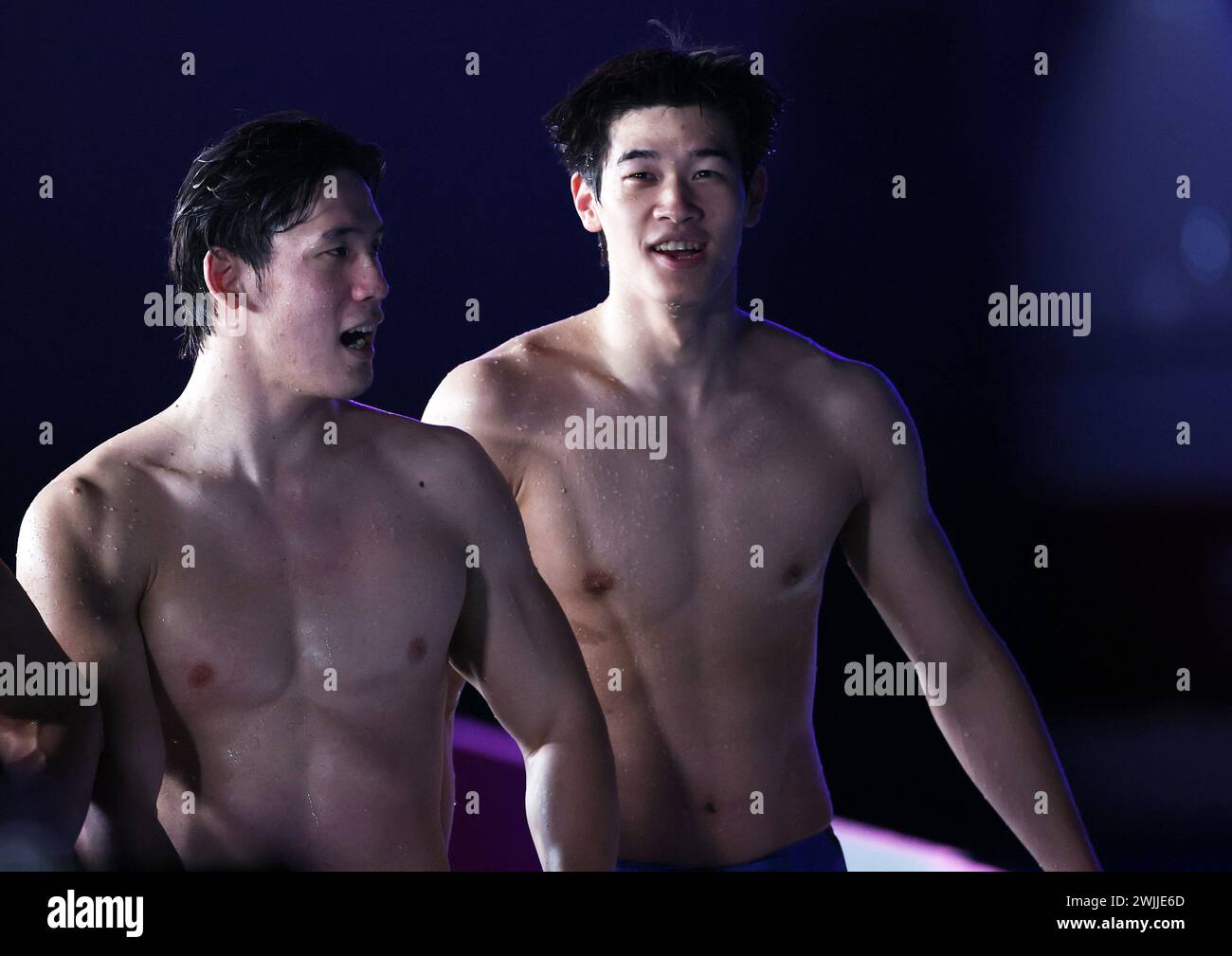 Doha, Qatar. 15th Feb, 2024. Pan Zhanle (R) of China reacts after the ...