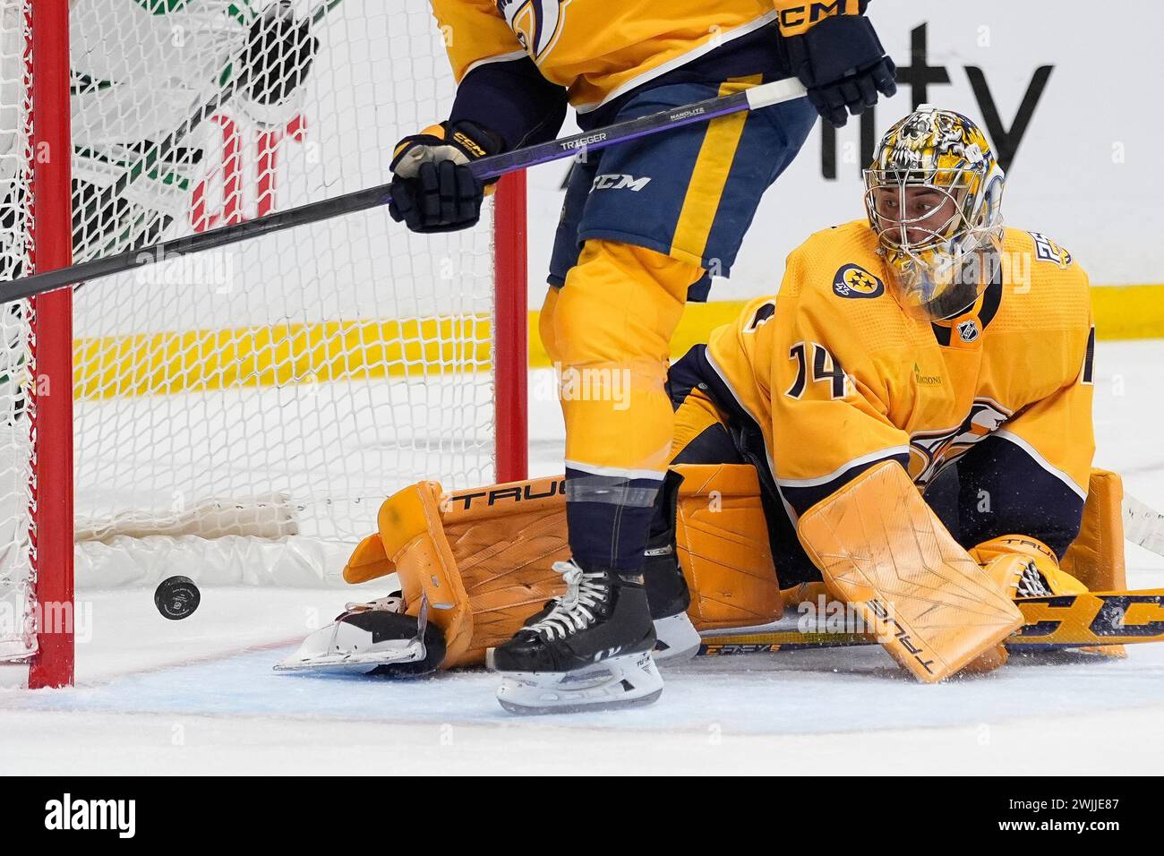 Nashville Predators goaltender Juuse Saros (74) looks back as the puck ...