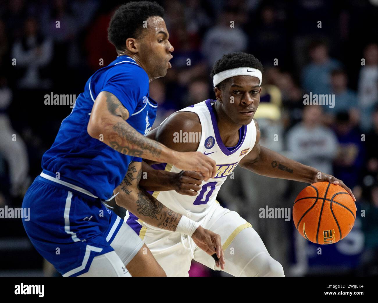 James Madison guard Xavier Brown (0) is defended by Georgia State guard ...