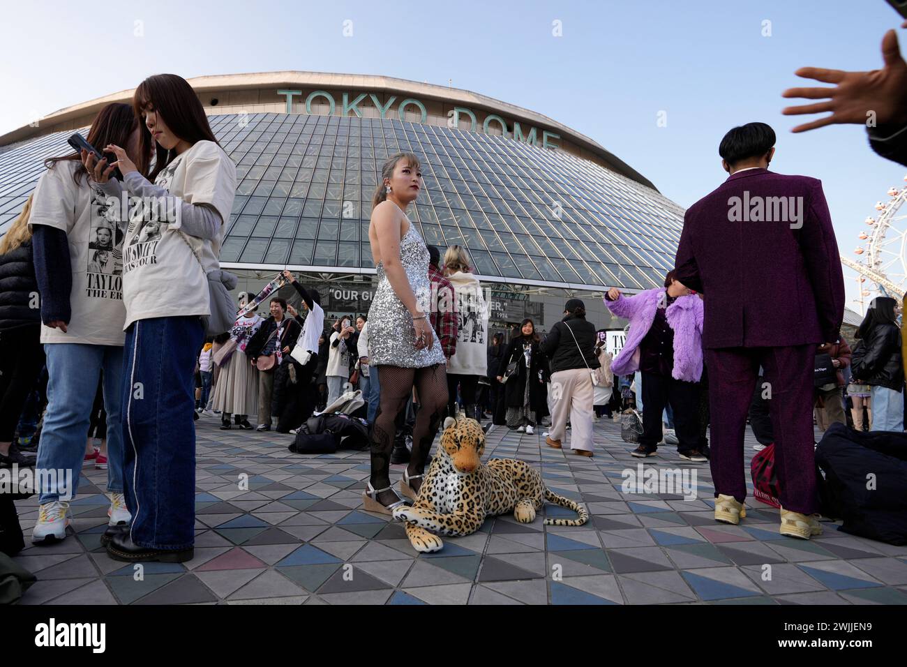 A woman poses for a photo with a stuffed animal of a leopard before ...