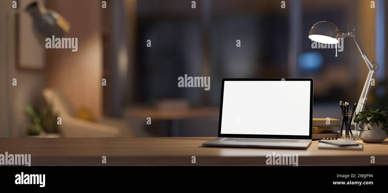 A modern, cozy home office at night with a white-screen laptop computer ...