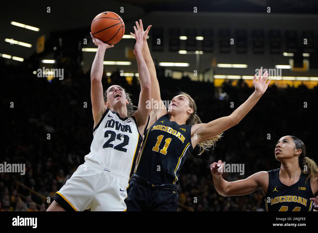 Iowa guard Caitlin Clark (22) pulls up for a shot as Michigan guard ...