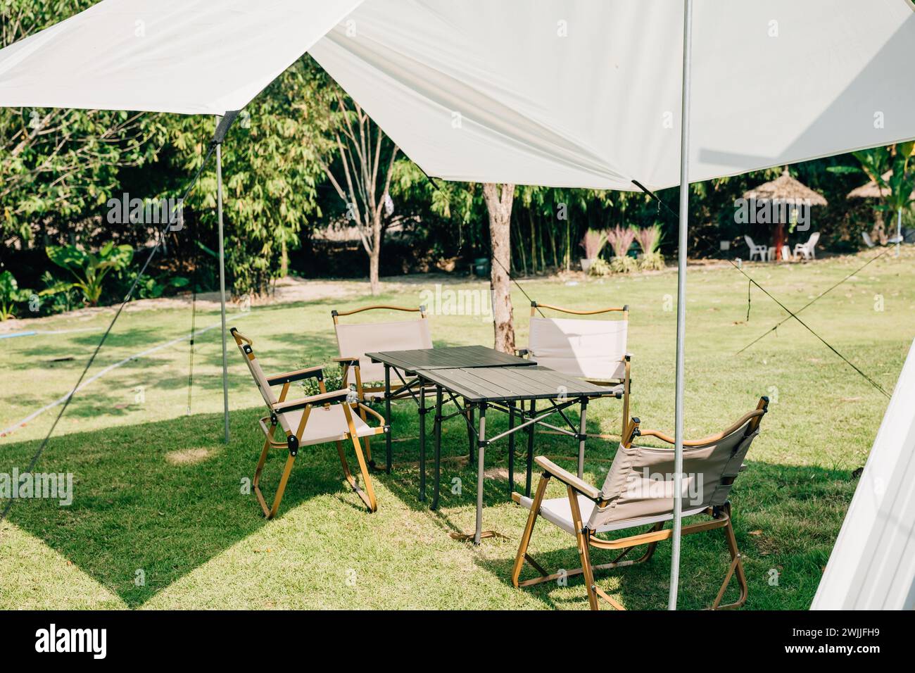 Set up your outdoor picnic with a summer camping tent, tables, and ...
