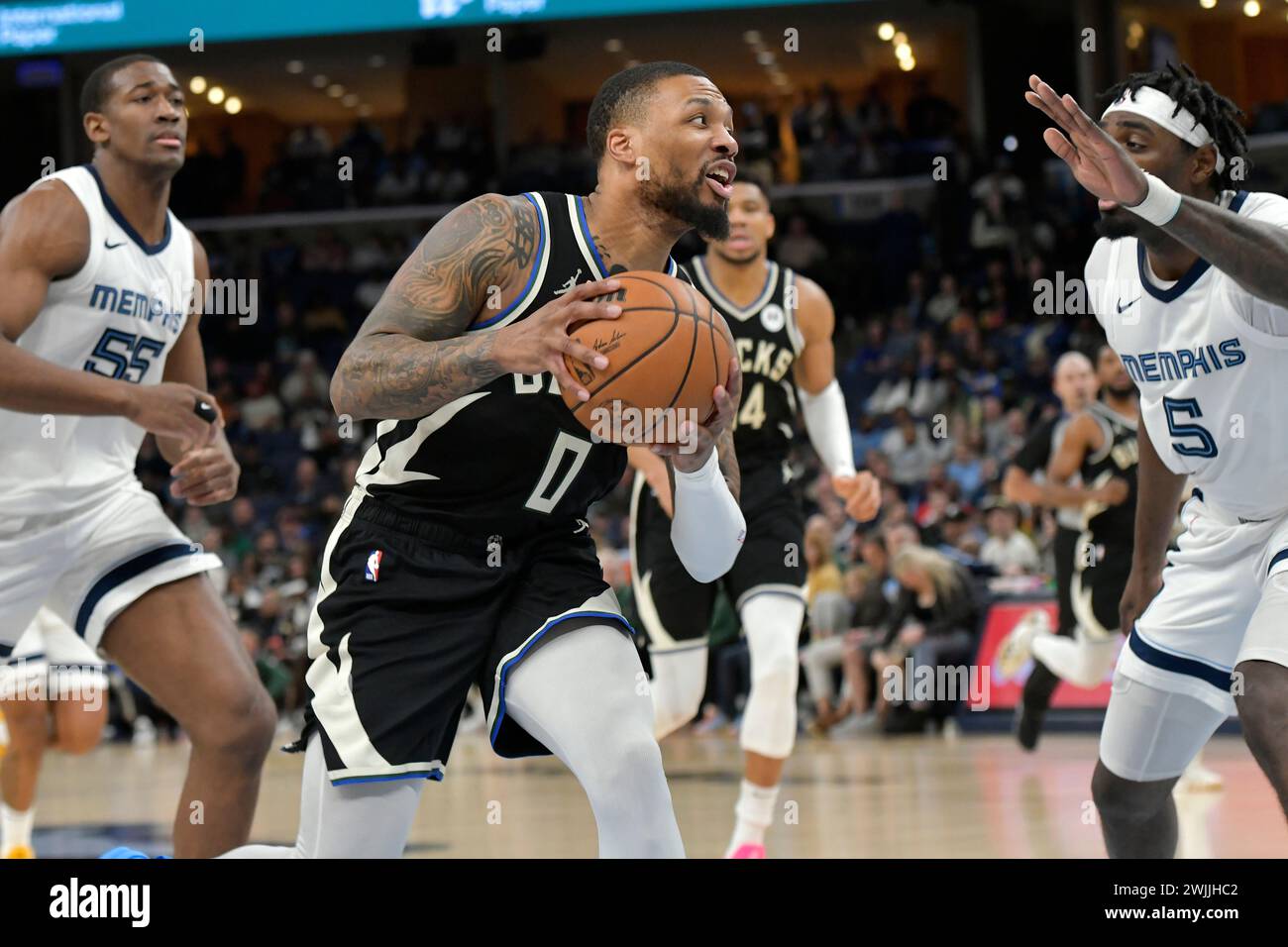 Milwaukee Bucks guard Damian Lillard (0) handles the ball ahead of ...
