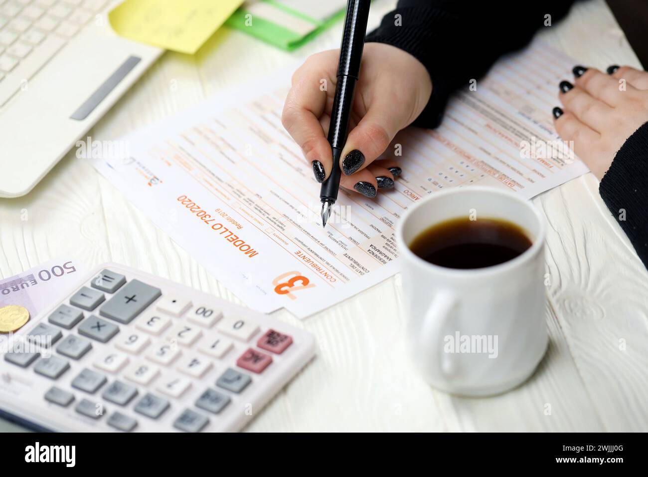 KYIV, UKRAINE - OCTOBER 31, 2023 Accountant fill italian tax form ...