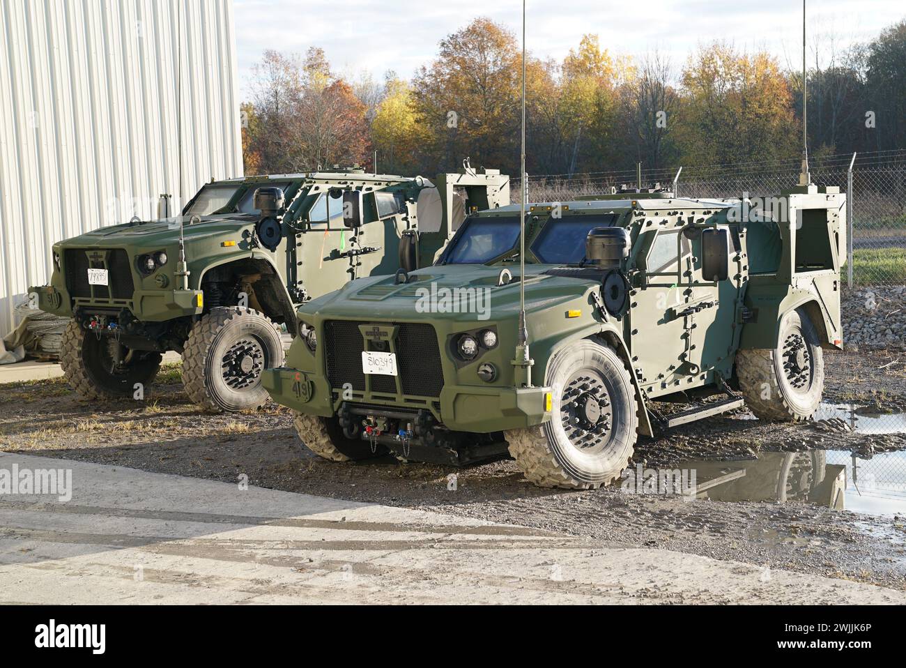 Two Joint Light Tactical Vehicles, showcasing the lowered and raised ...