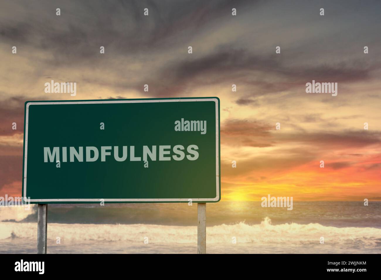 Road sign with mindfulness text and ocean view with sunset scene ...