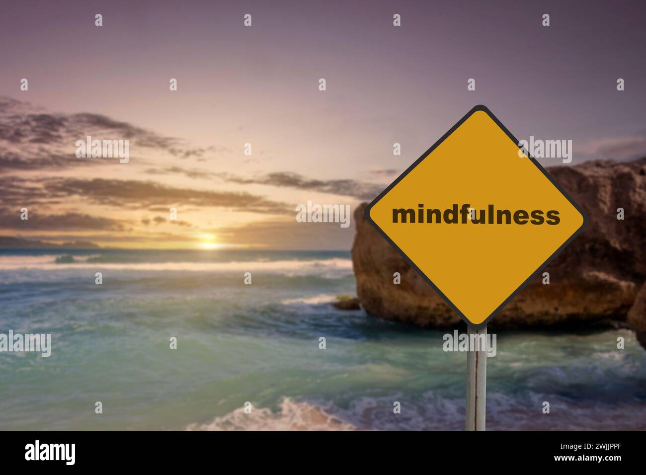 Road sign with mindfulness text and ocean view with sunset scene ...