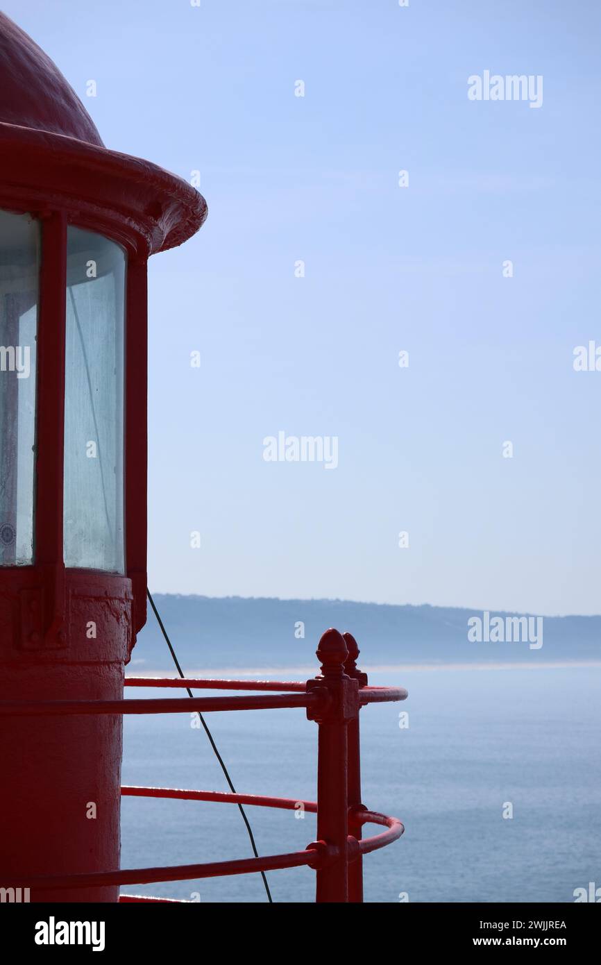 Red lighthouse atop ocean floor Stock Photo - Alamy