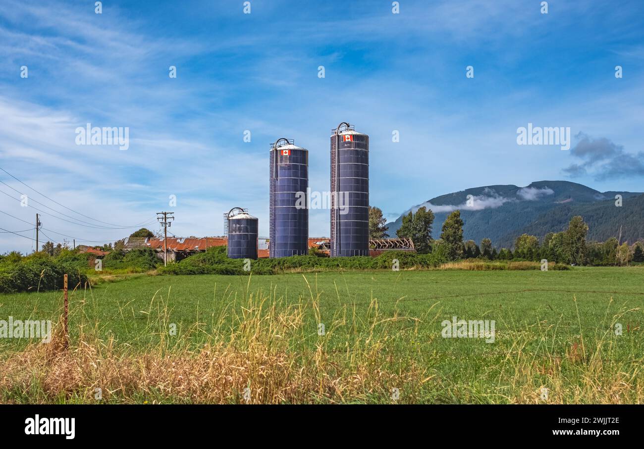 Large iron barrels of grain. Granary elevator. Plant for storage and ...