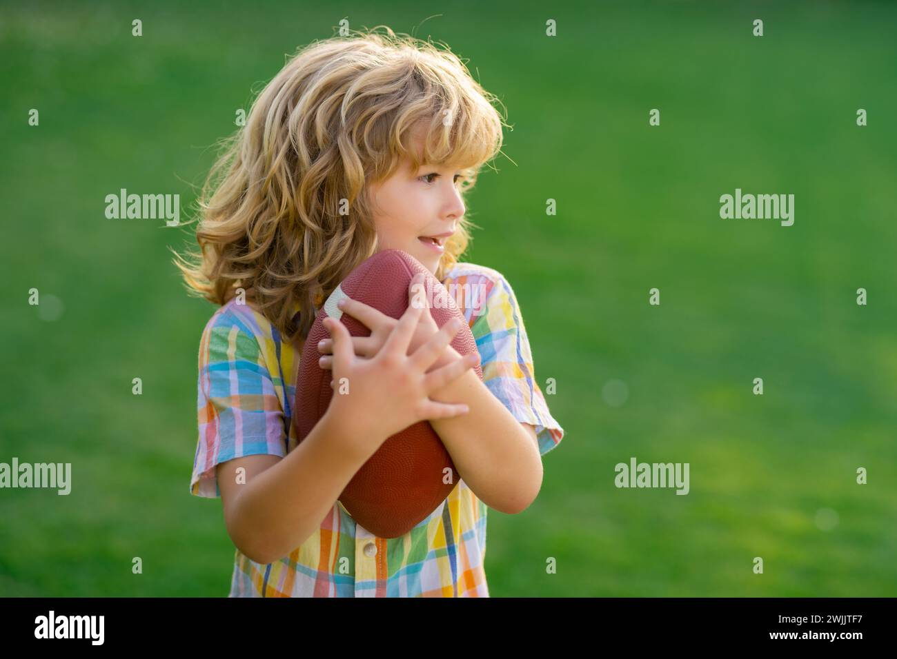 Portrait of child with rugby ball. Kids and sports. Young boy playing ...