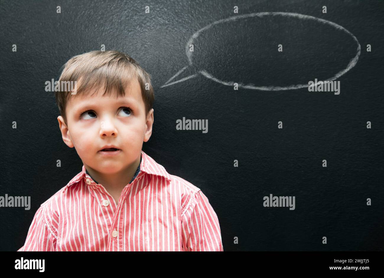 Child, boy and thinking with speech bubble on blackboard for creative idea, drawing and ...