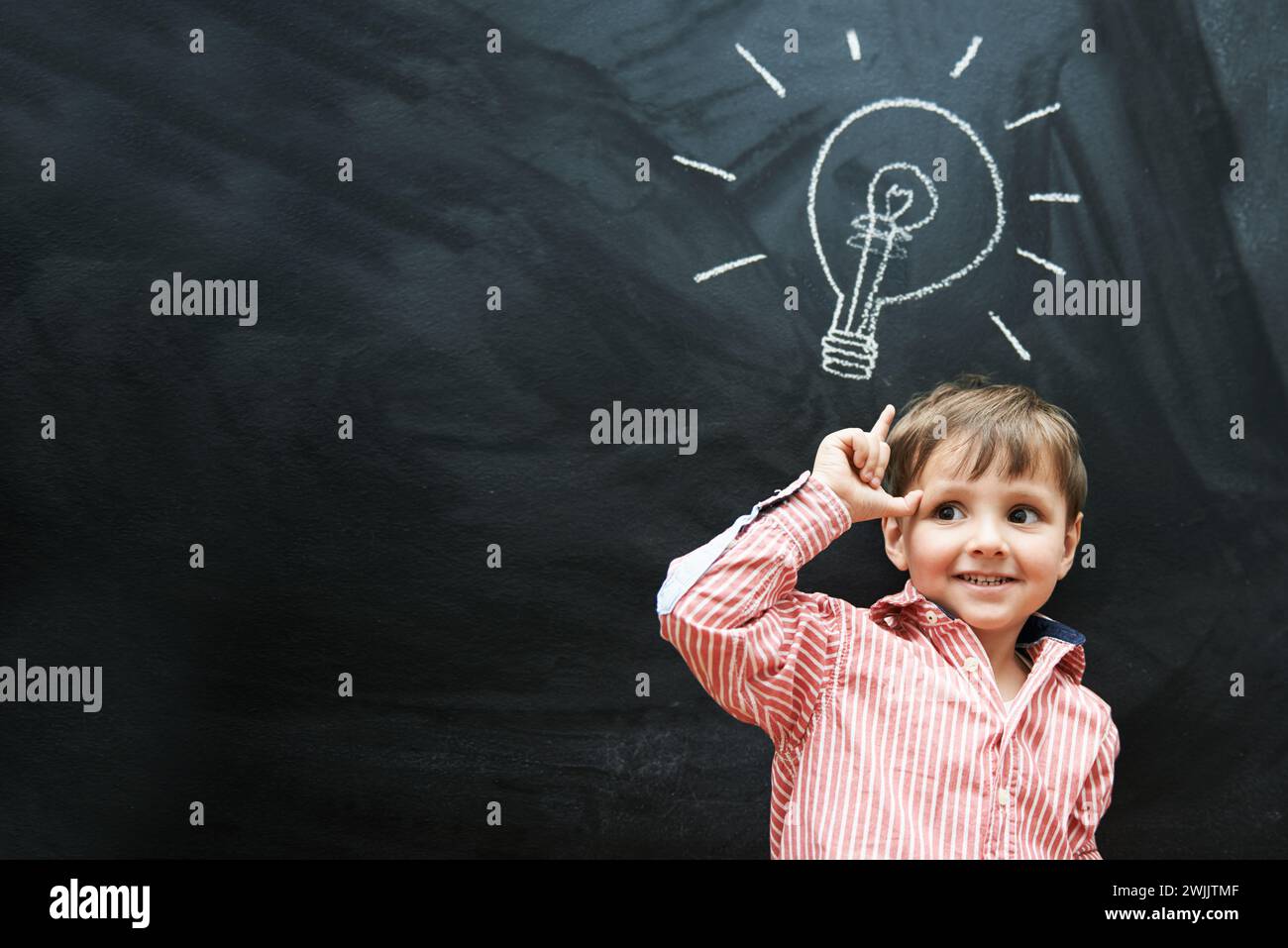 Child, thinking and lightbulb on chalkboard for solution, learning and ...