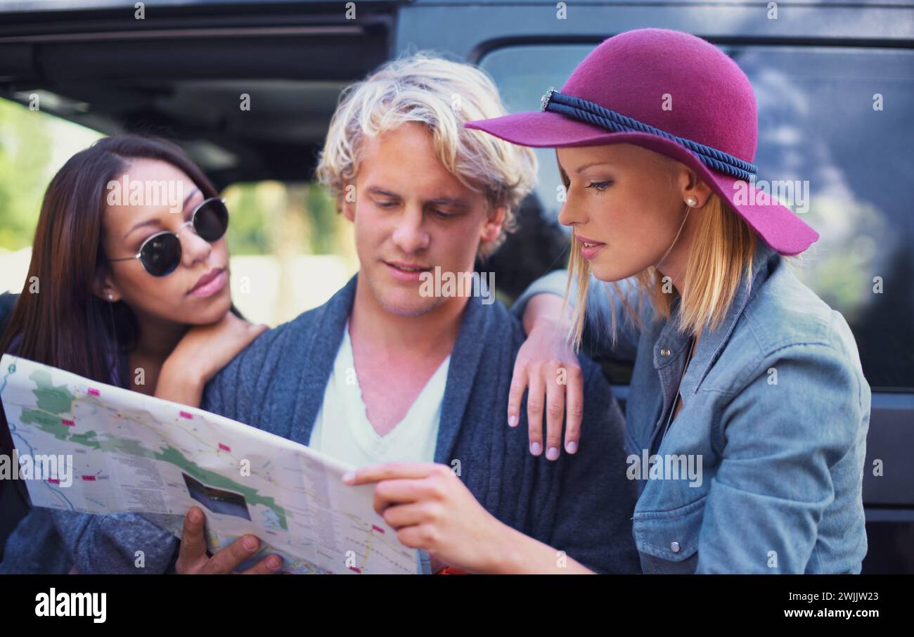 People, friends and map for road trip in search of direction, guide or ...