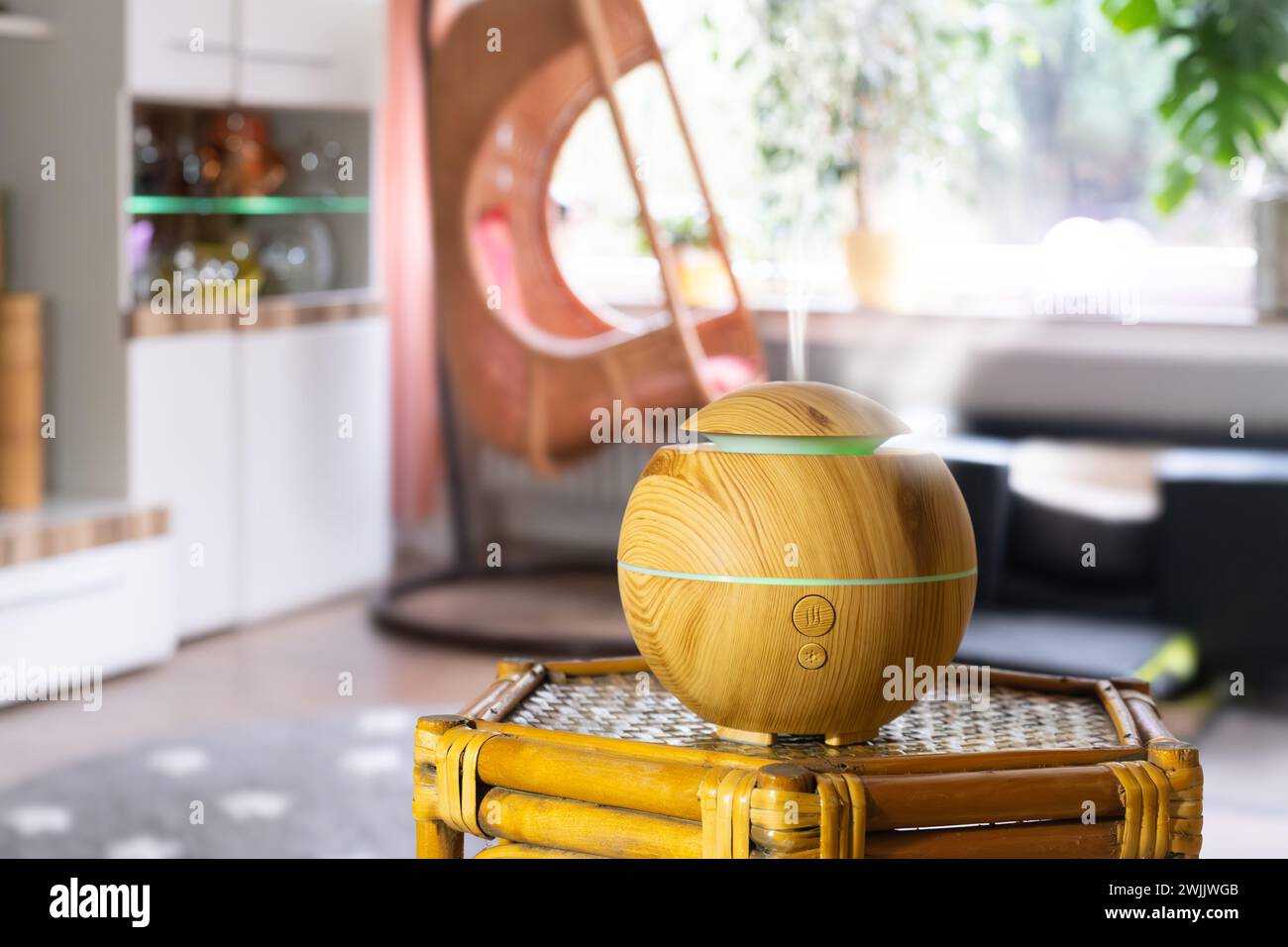A diffuser distributes flavored water as steam in the living room Stock ...