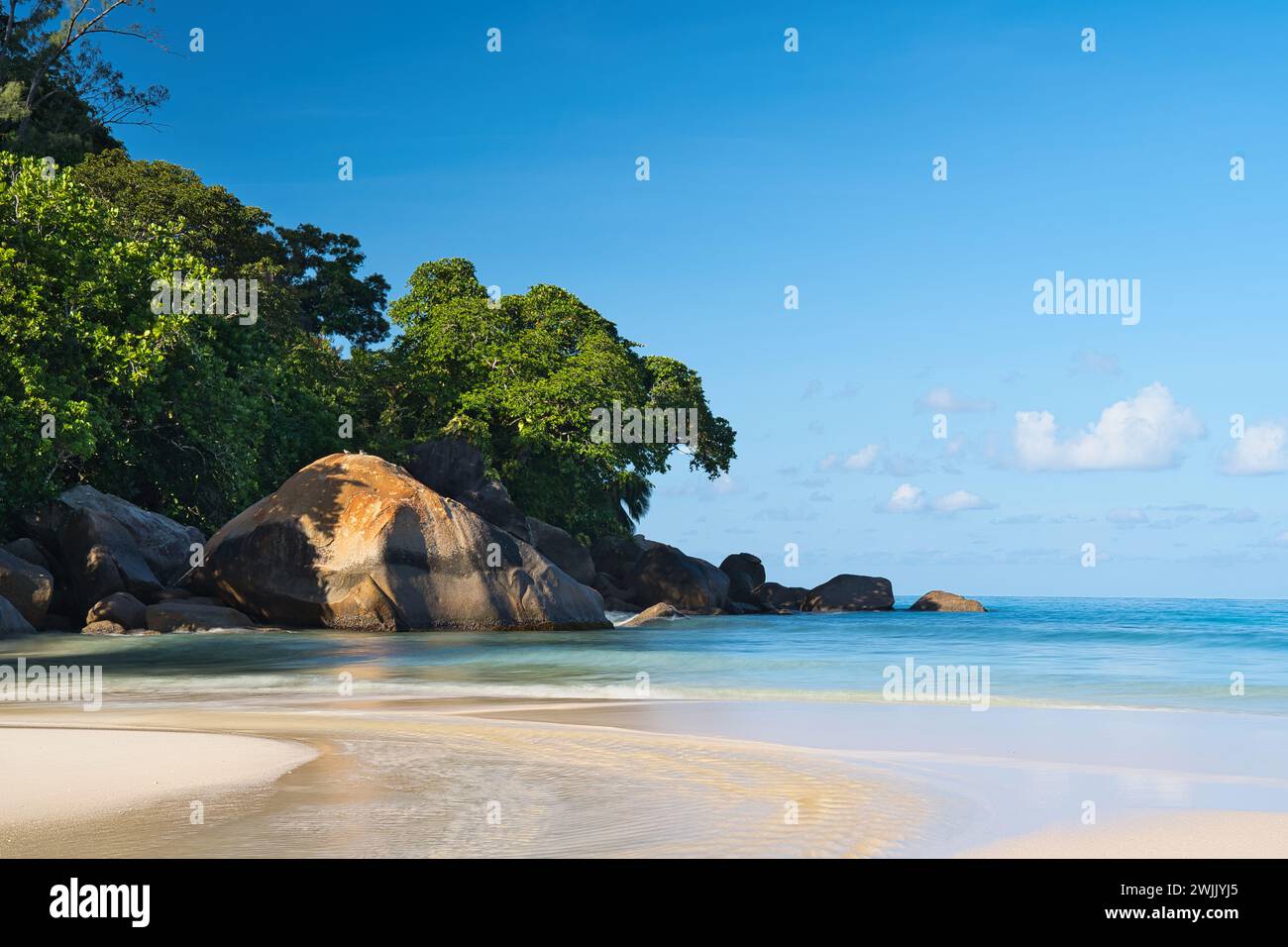 1 second long exposure of beautiful white sandy beach, granite rock ...