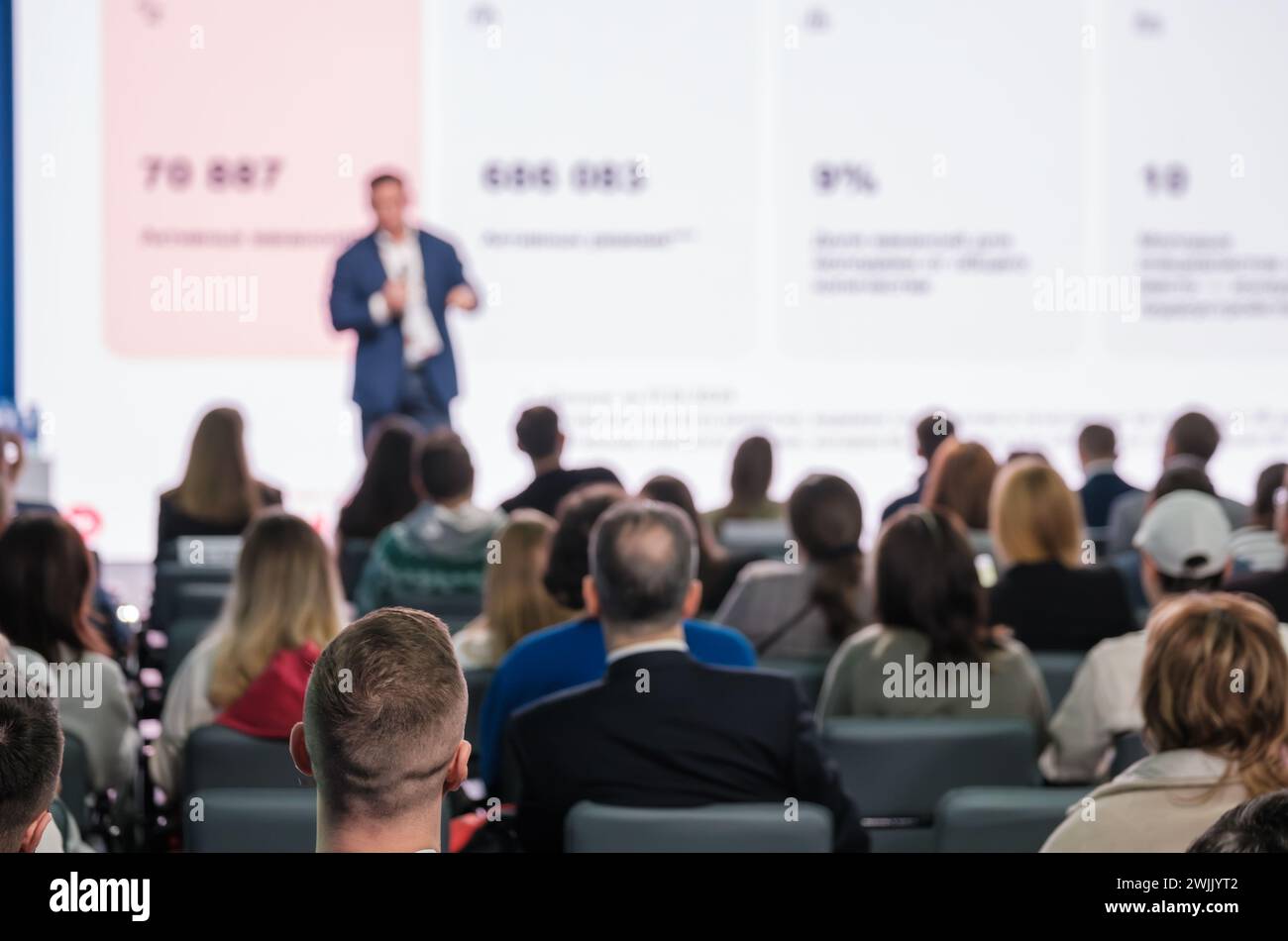 Blurred view of a professional speaker at a business seminar engaging ...