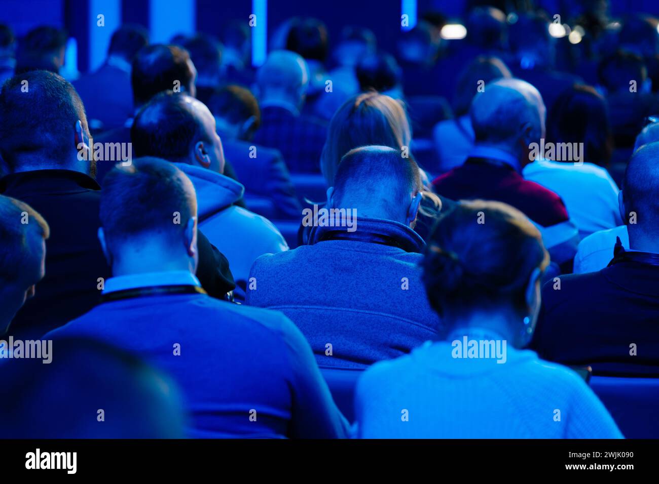 Back view of attendees at a professional conference event focused on a ...