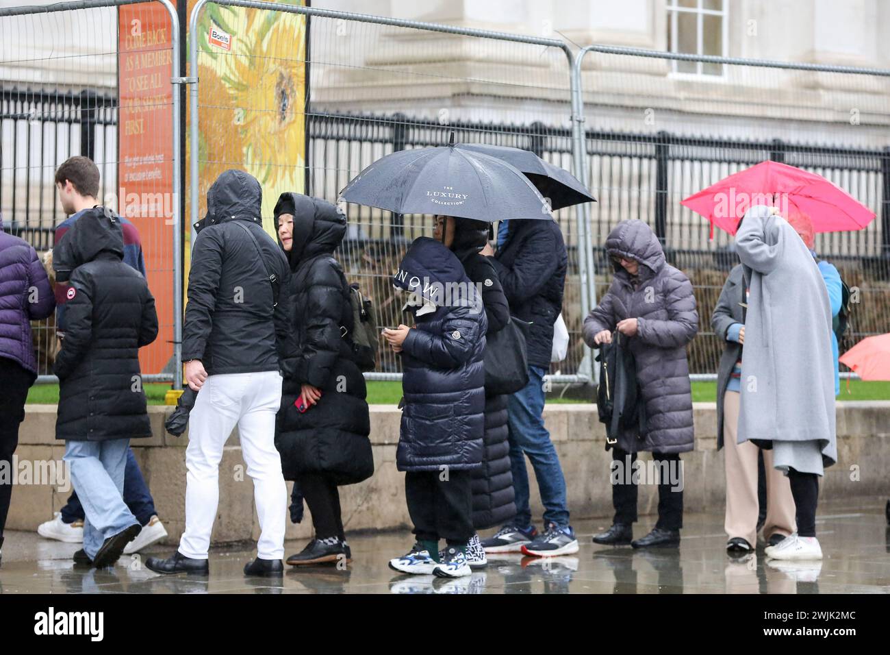 People shelter under umbrellas during rainfall in central London Stock ...