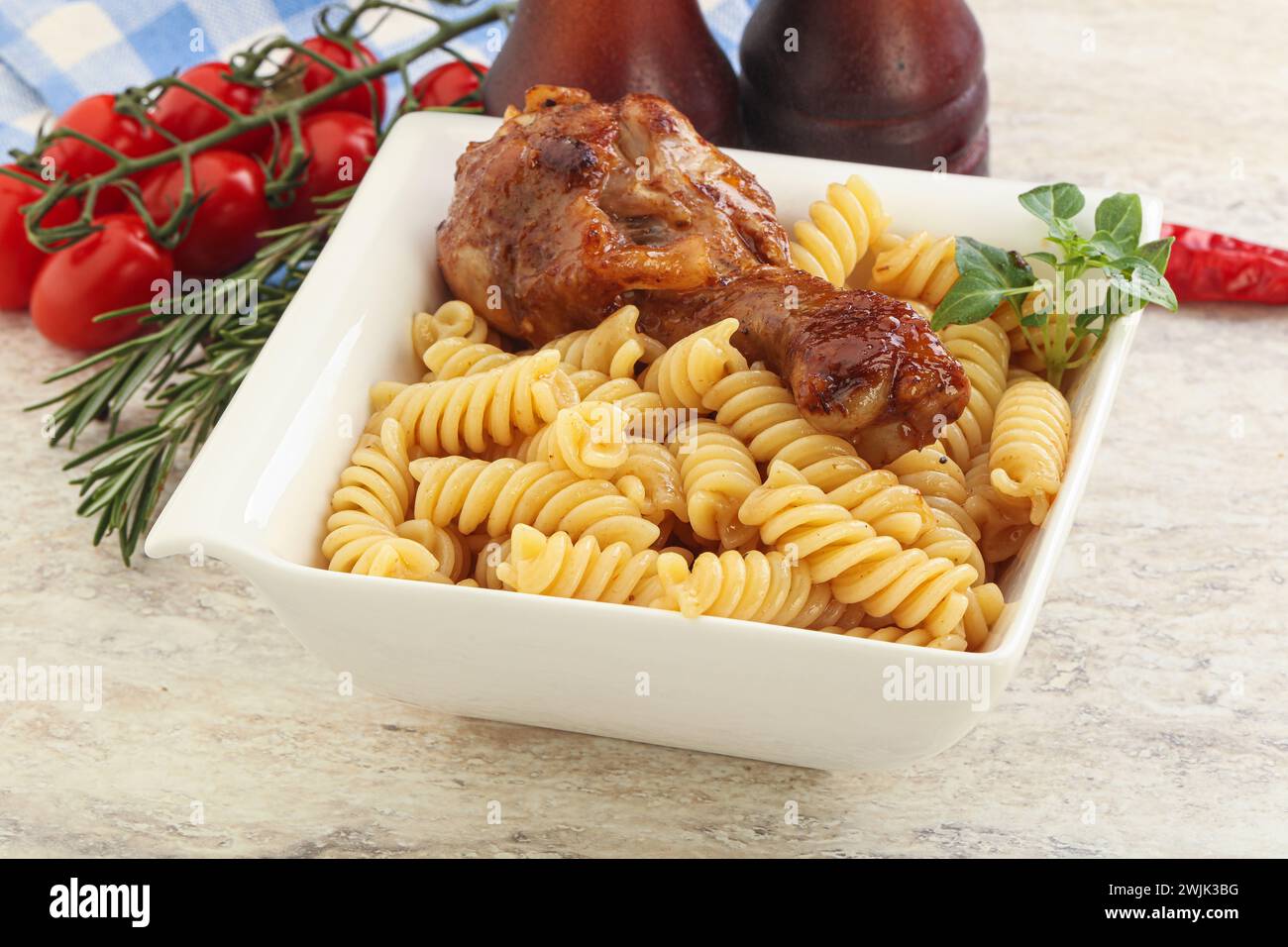 Roasted chicken leg with macaroni pasta Stock Photo - Alamy