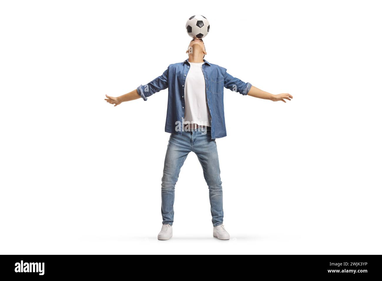 Casual young man holding football with head isolated on white ...