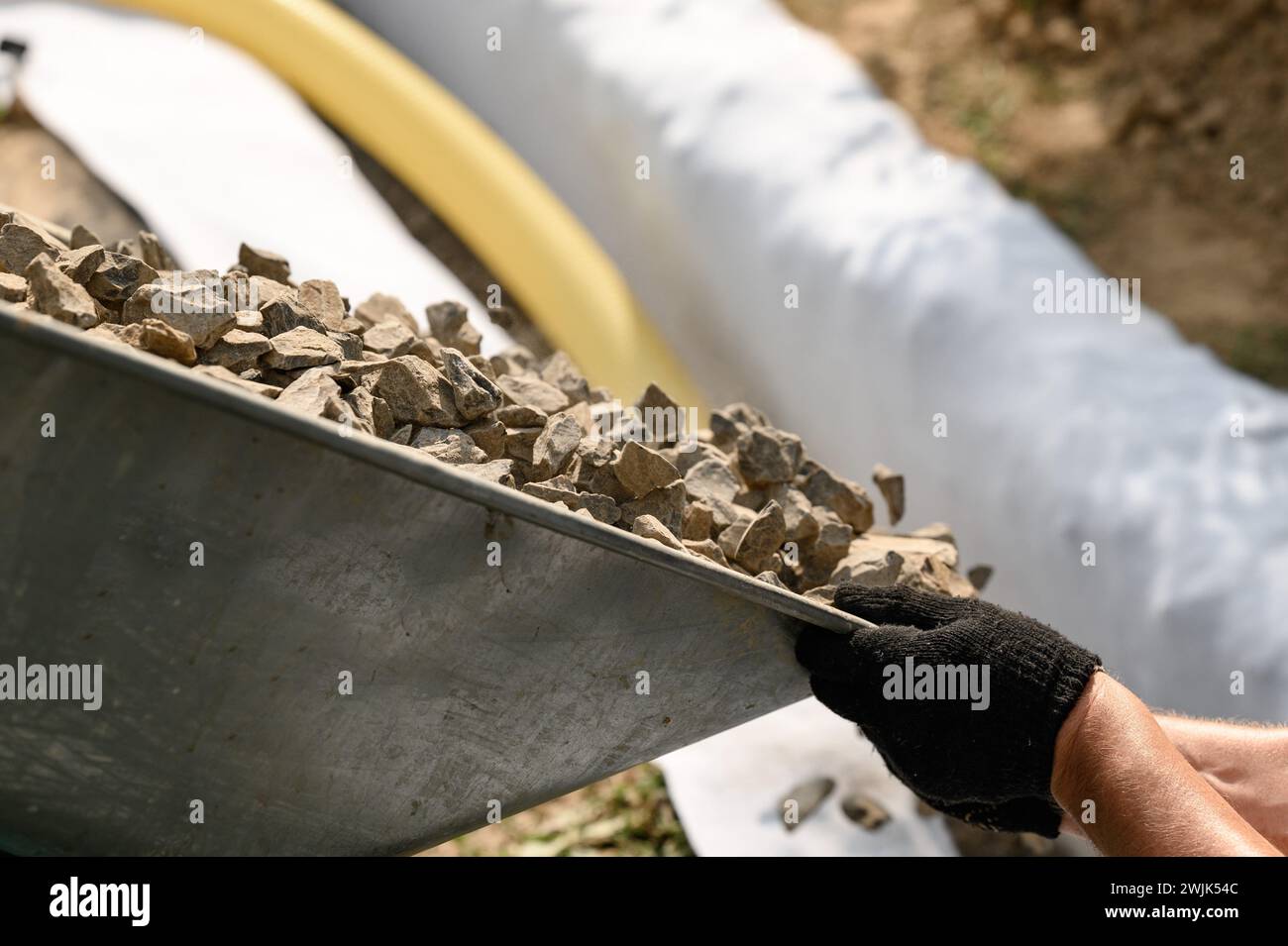 Drainage works for drainage of ground water around the field. A man ...