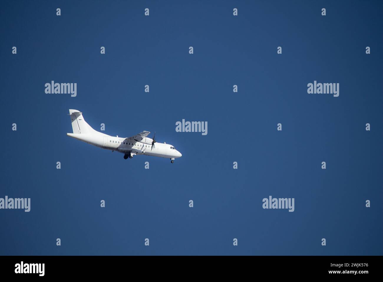 airplane preparing the landing with a blue sky Stock Photo - Alamy