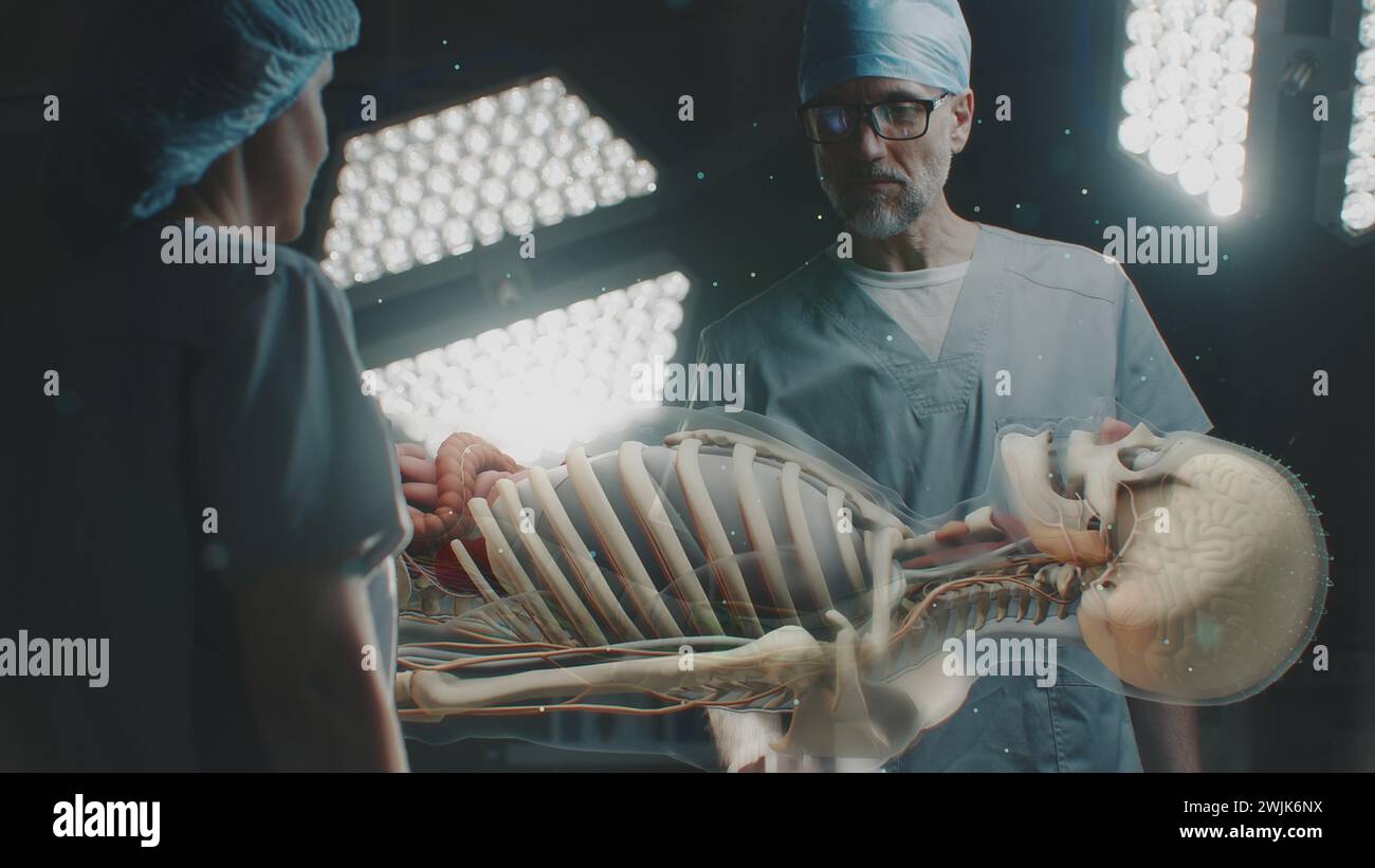 Male and female surgeons work in modern operating room using futuristic ...