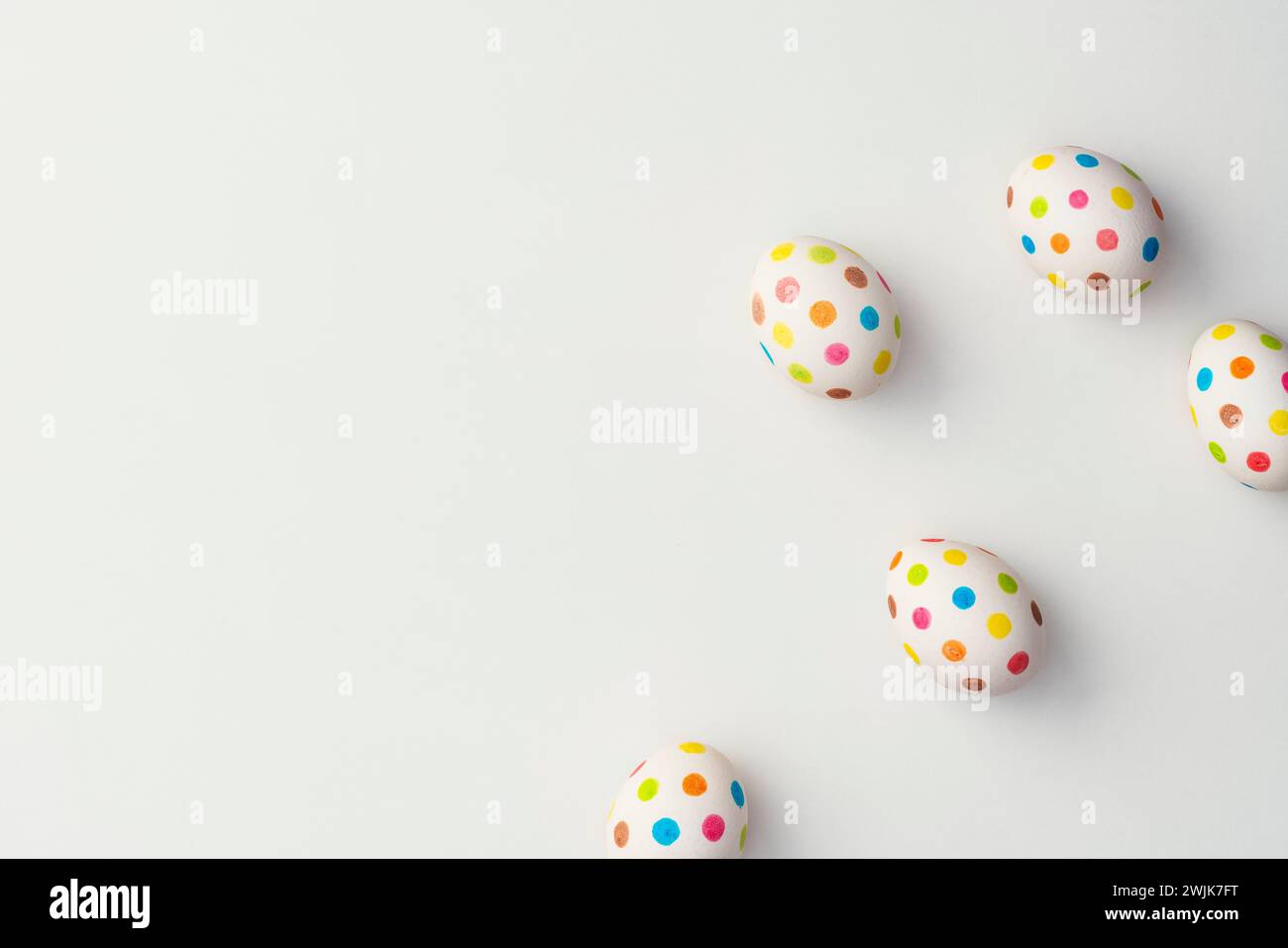 Hand painted colourful spotty easter eggs on white background. Directly ...