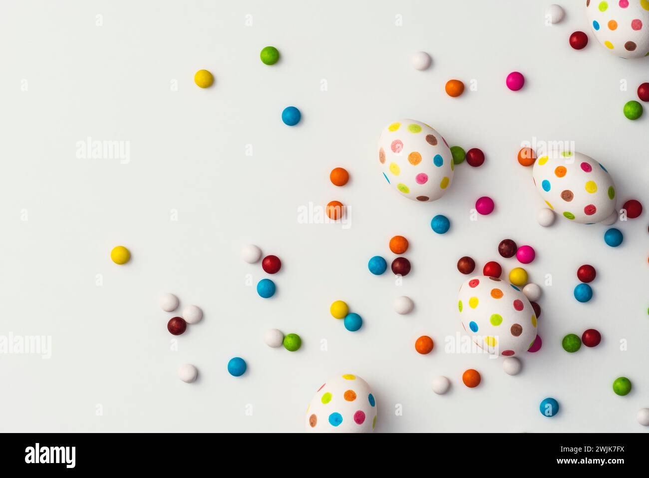Hand painted colourful spotty easter eggs and colourful chocolate beans ...