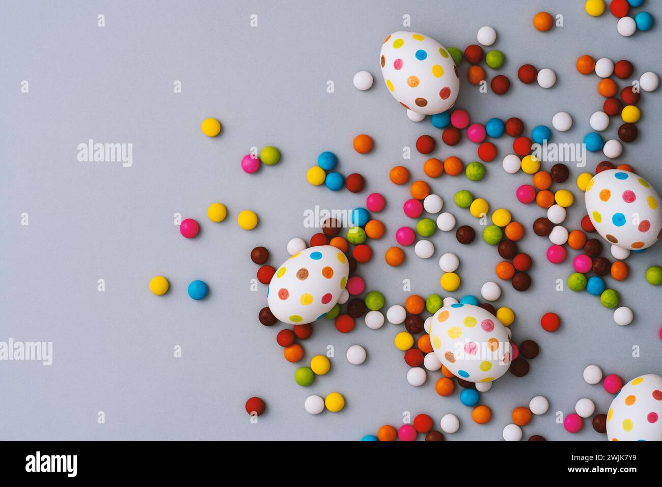 Spotty painted colorful easter eggs and colorful chocolate bean candies ...