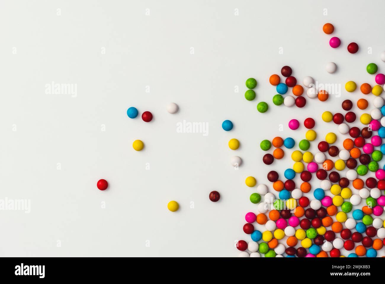 Colorful sugar coated chocolate beans on white background. Directly ...