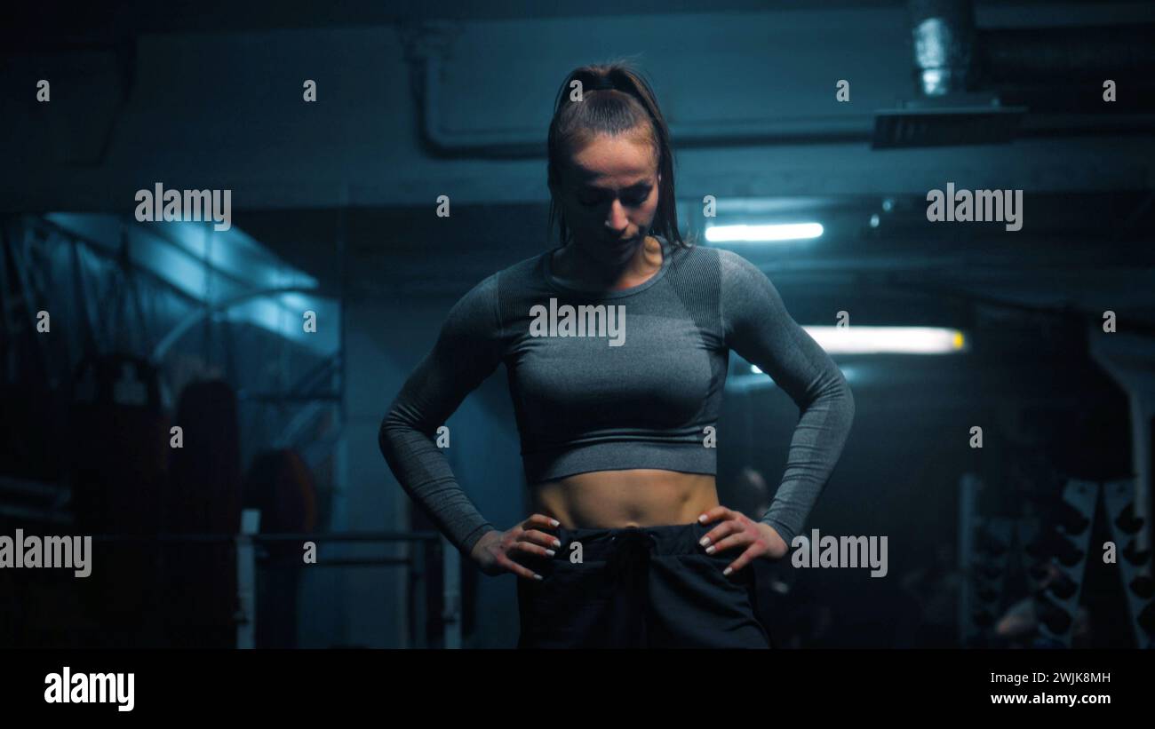 Strong woman with athletic body wearing sportswear lifts and does ...