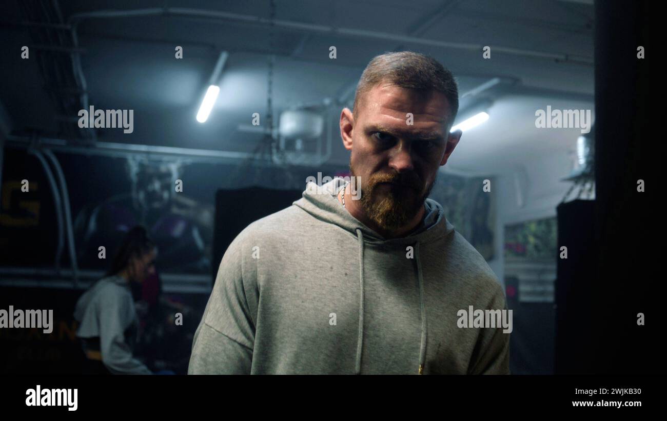 Male boxer in boxing bandages trains and hits punching bag. Athletic ...