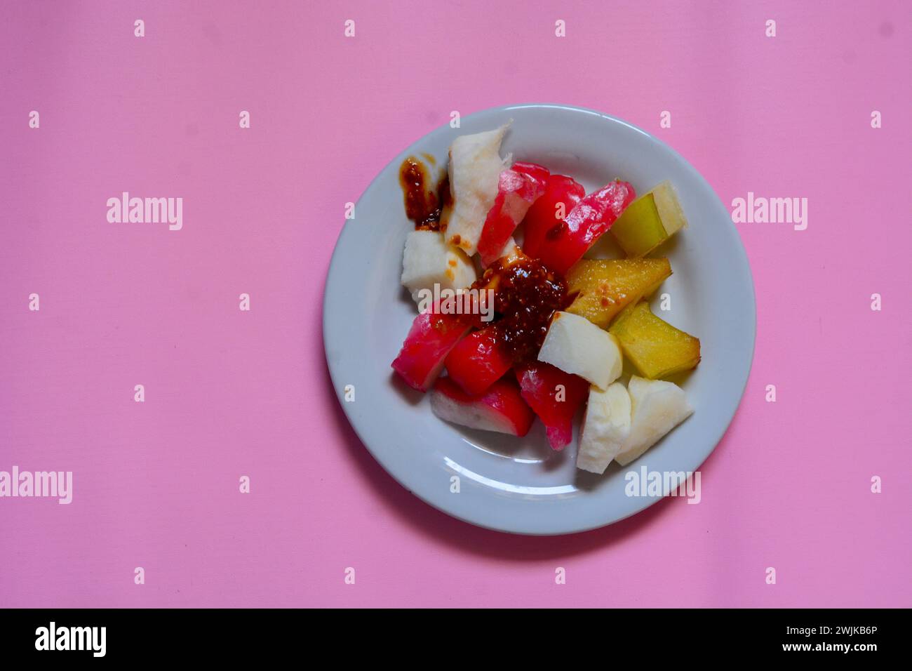 Photo of a variety of fruit "Rujak" with sauce made from brown sugar ...