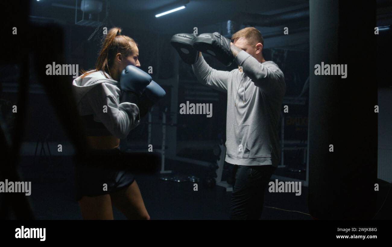 Athletic fighter in boxing gloves trains and exercises for fighting ...